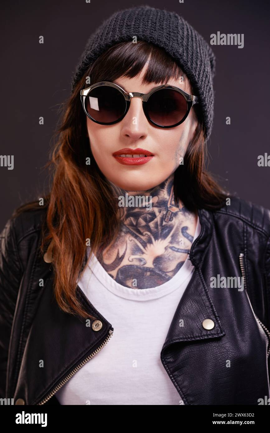 Confident, woman and punk fashion in studio for trendy rocker style ...