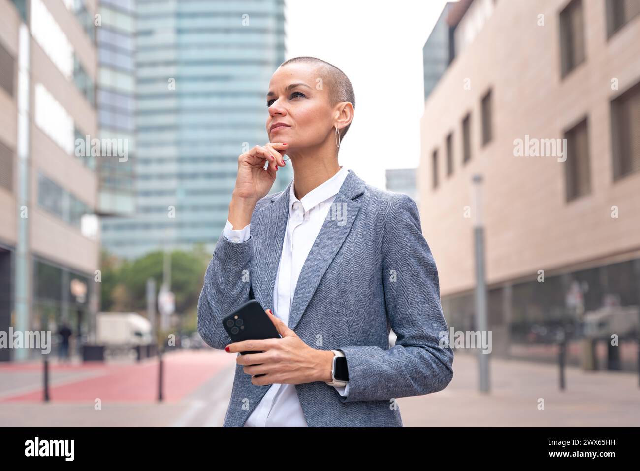 Caucasian business woman with pensive face using an app on her ...