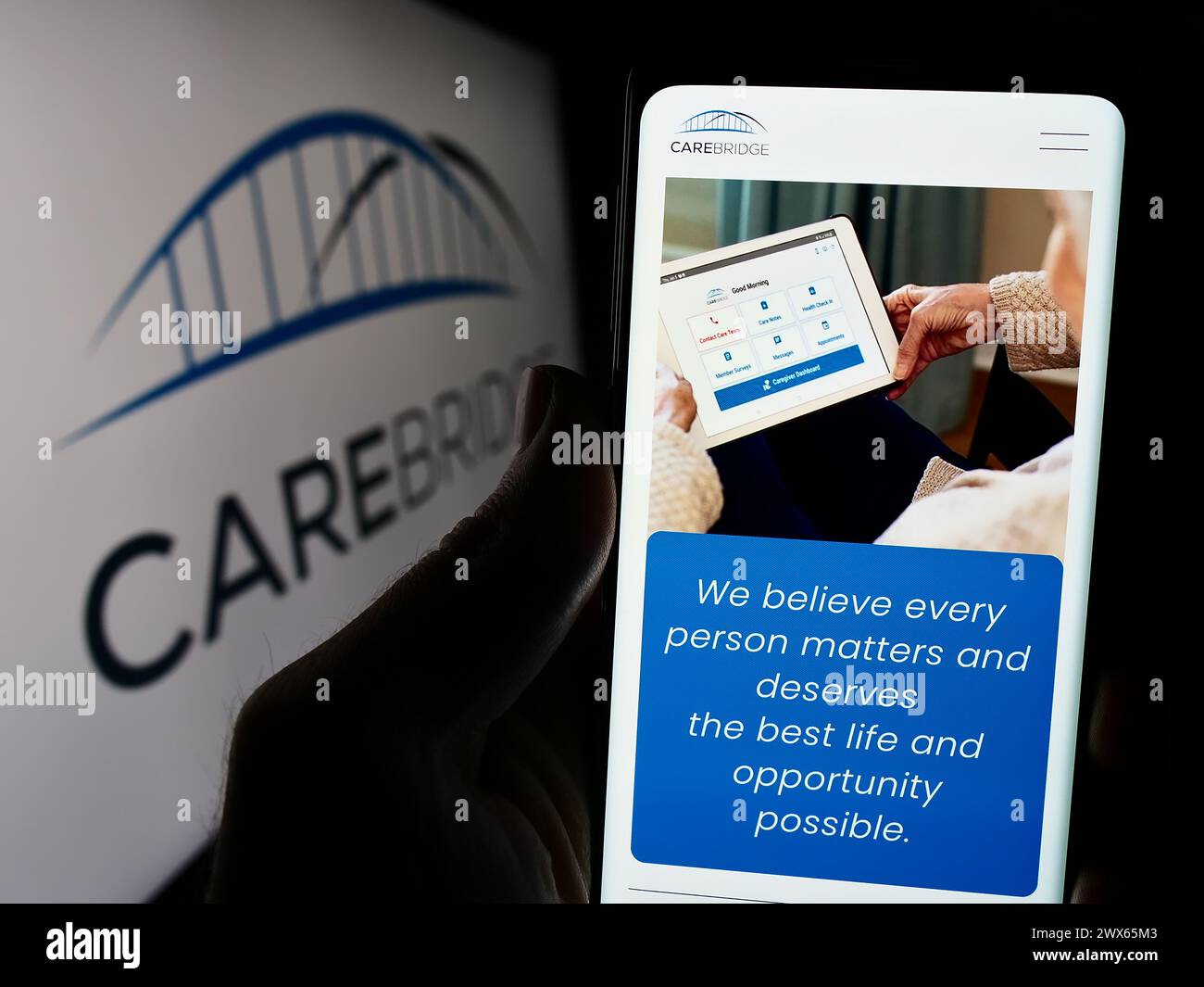 Person holding cellphone with webpage of US health care company ...