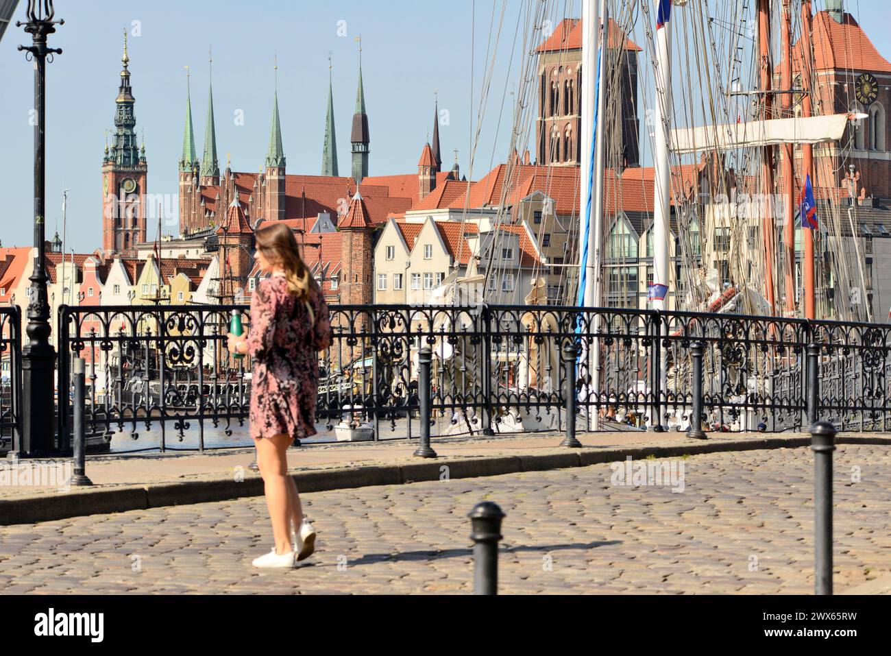 Gdansk Poland lone young woman on Wapienniczy Bridge with Old Town ...