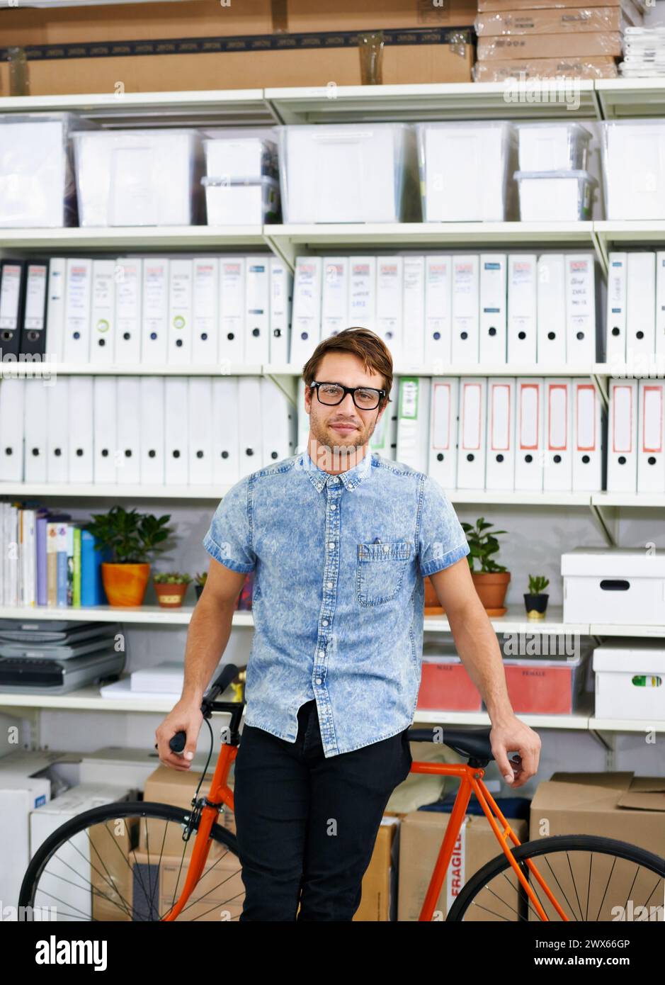 Portrait, manager and bike in office with cardboard boxes for commute ...