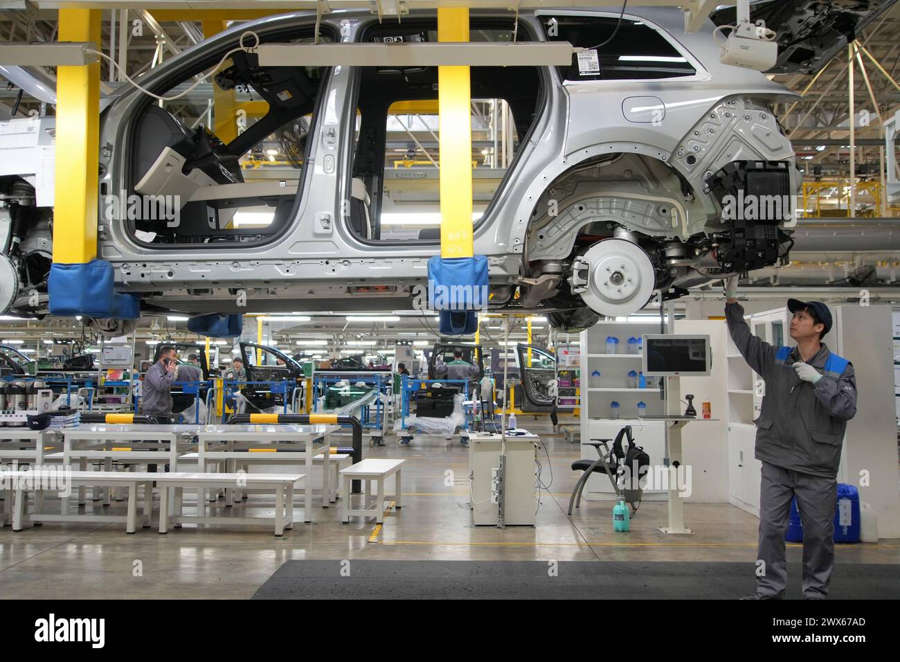 CHANGZHOU, CHINA - MARCH 27, 2024 - A worker is assembling auto parts on a production line at Li ...