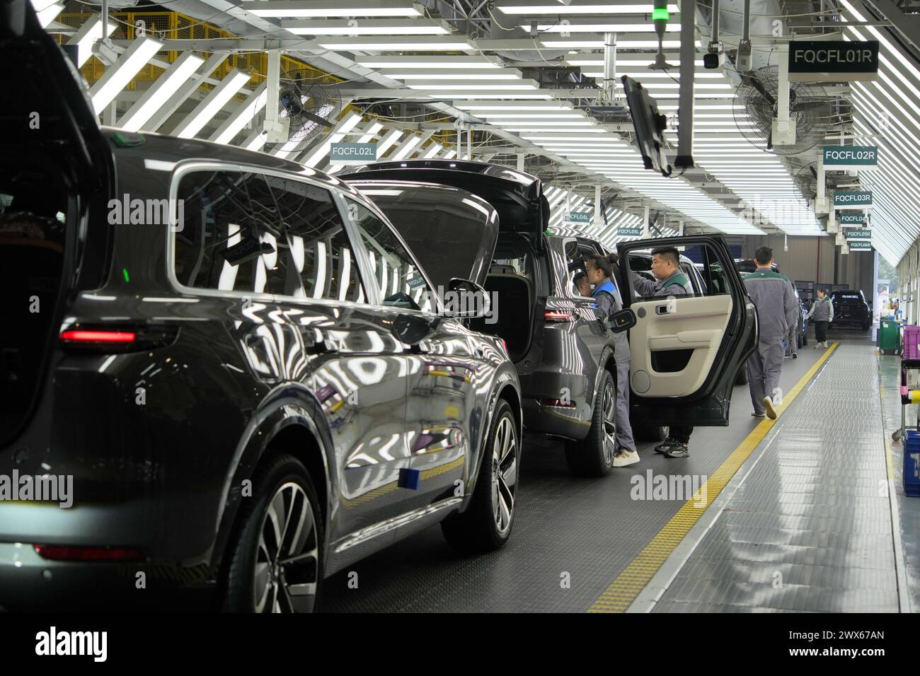 CHANGZHOU, CHINA - MARCH 27, 2024 - A worker is assembling auto parts ...
