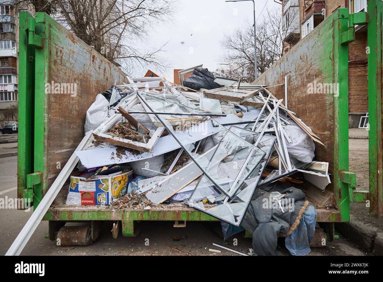 Dumpster with shattered windows after russian air strike. Trash bin ...