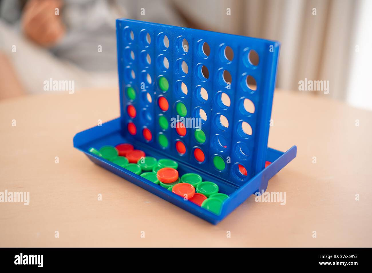 A close-up shot of a partially completed Connect Four game, showing an ...