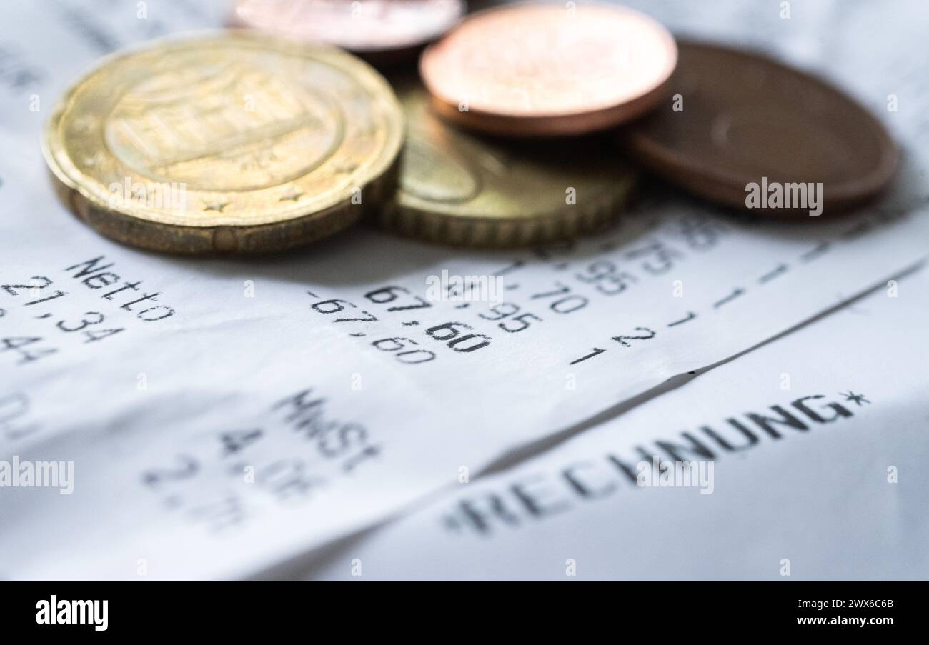 Stuttgart, Germany. 28th Mar, 2024. Coins lie on a till receipt. The ...