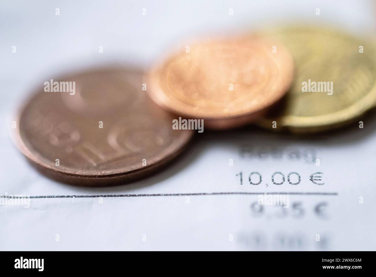 Stuttgart, Germany. 28th Mar, 2024. Coins lie on a till receipt. The ...