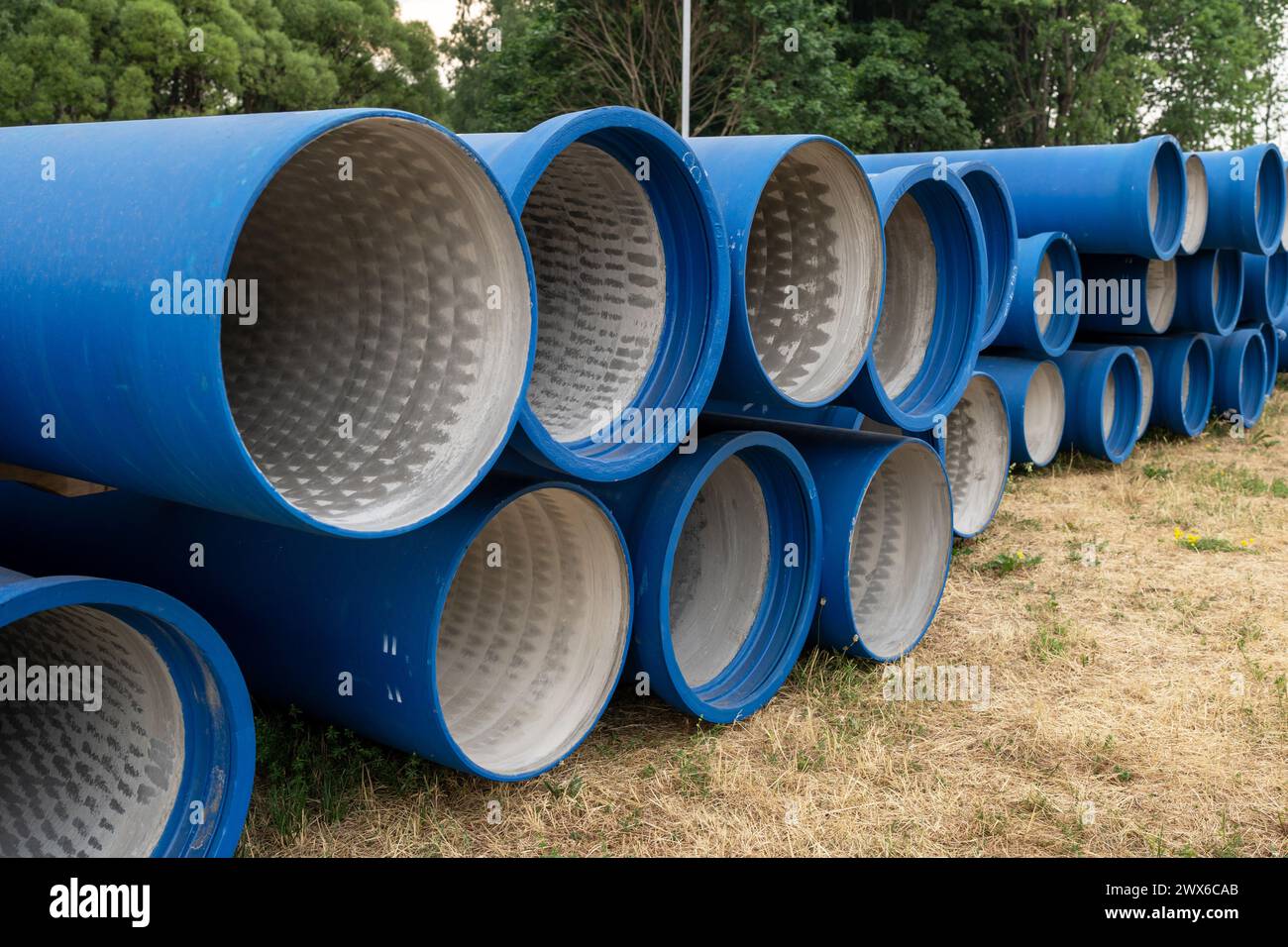 Concrete pipes covered with blue waterproofing at construction site ...