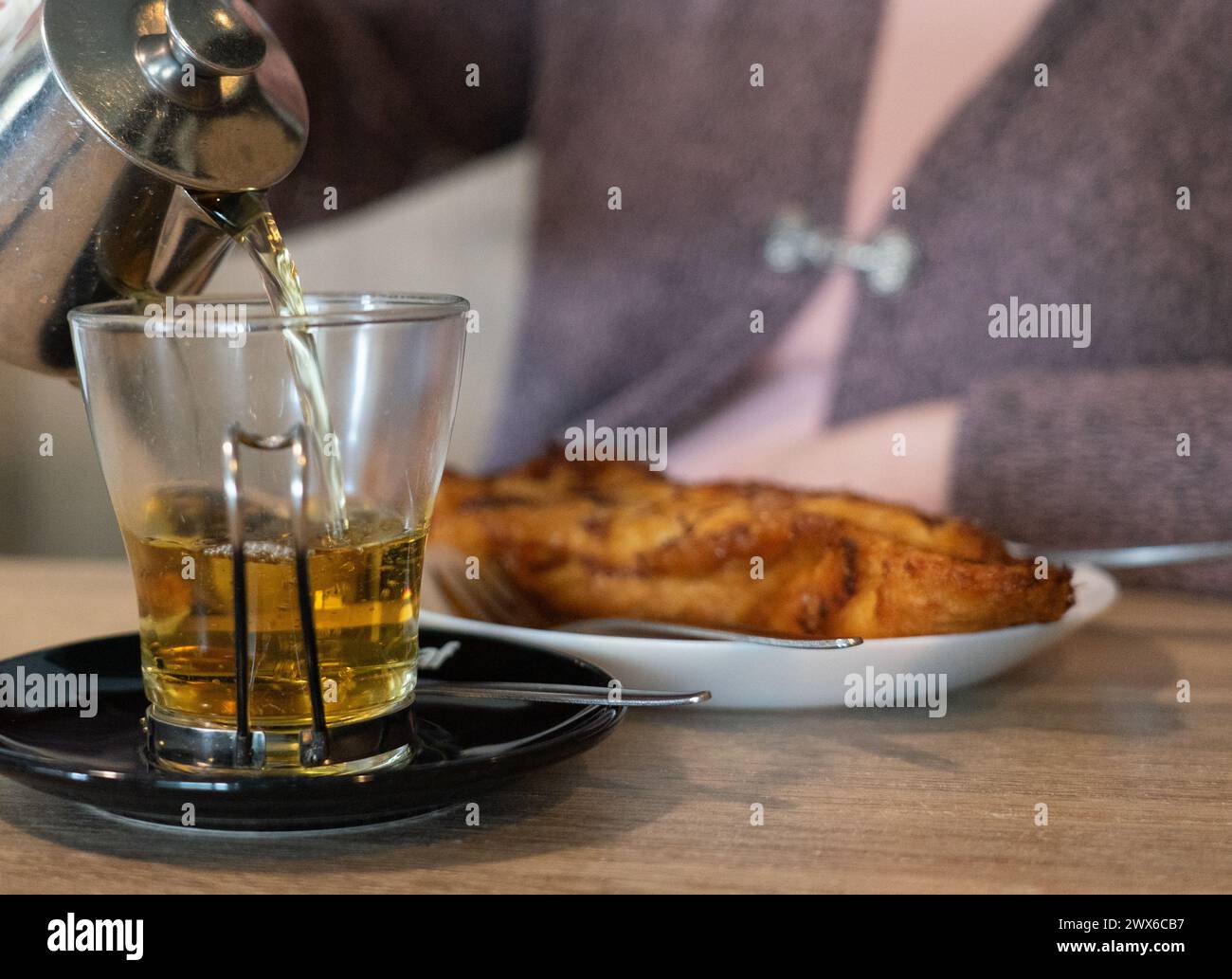 A typical Spanish Easter torrija and a tea on a table in a cafeteria ...