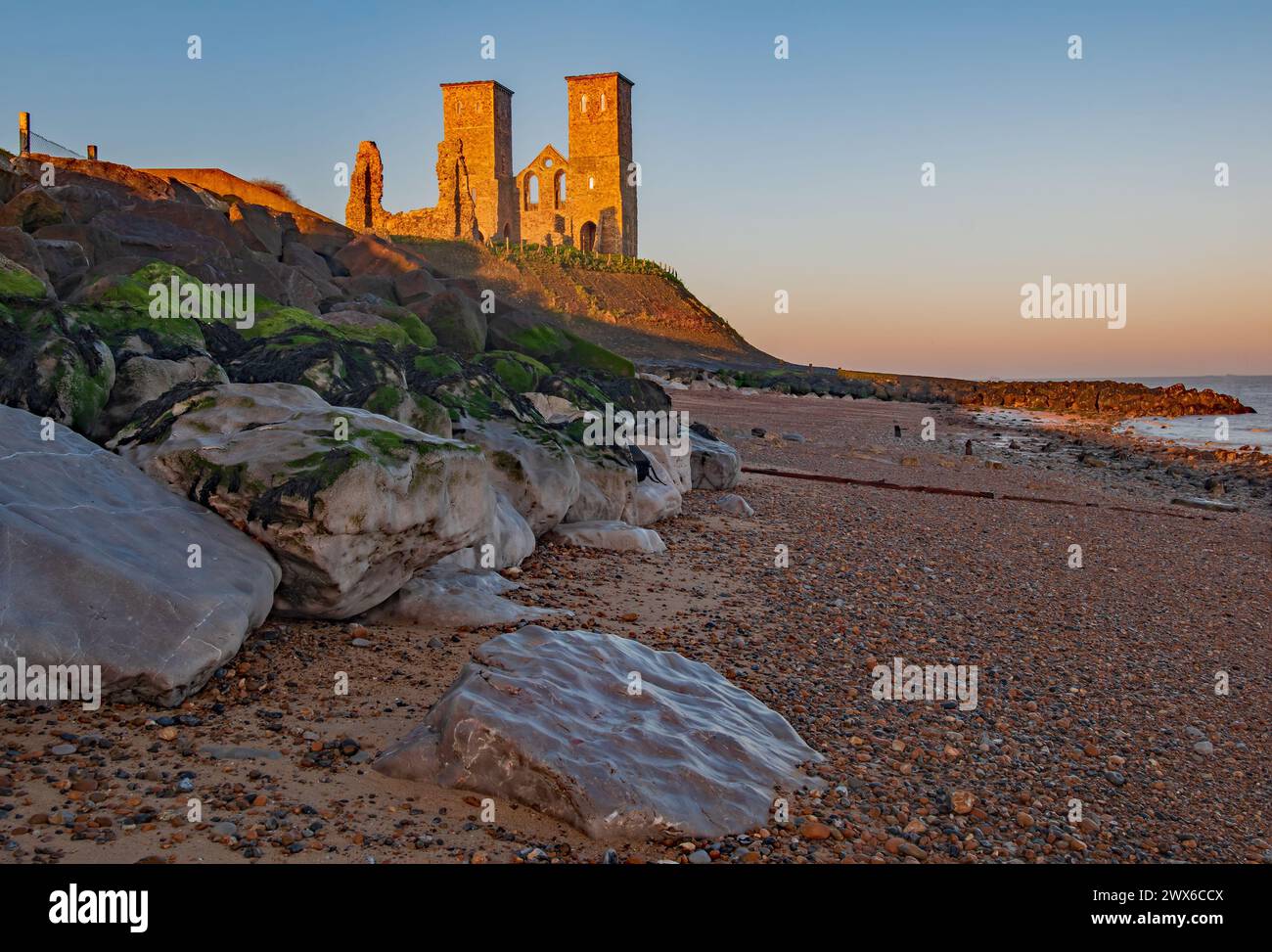 Reculver Towers Kent from the beach on a red dawn glowing morning Stock ...