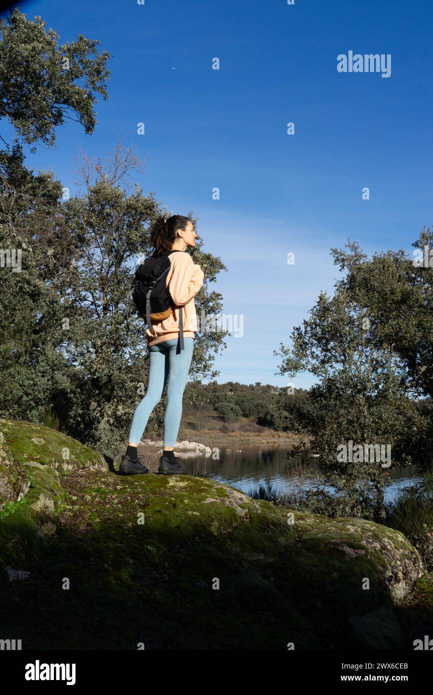 Woman hiking in nature alone with her backpack Stock Photo - Alamy