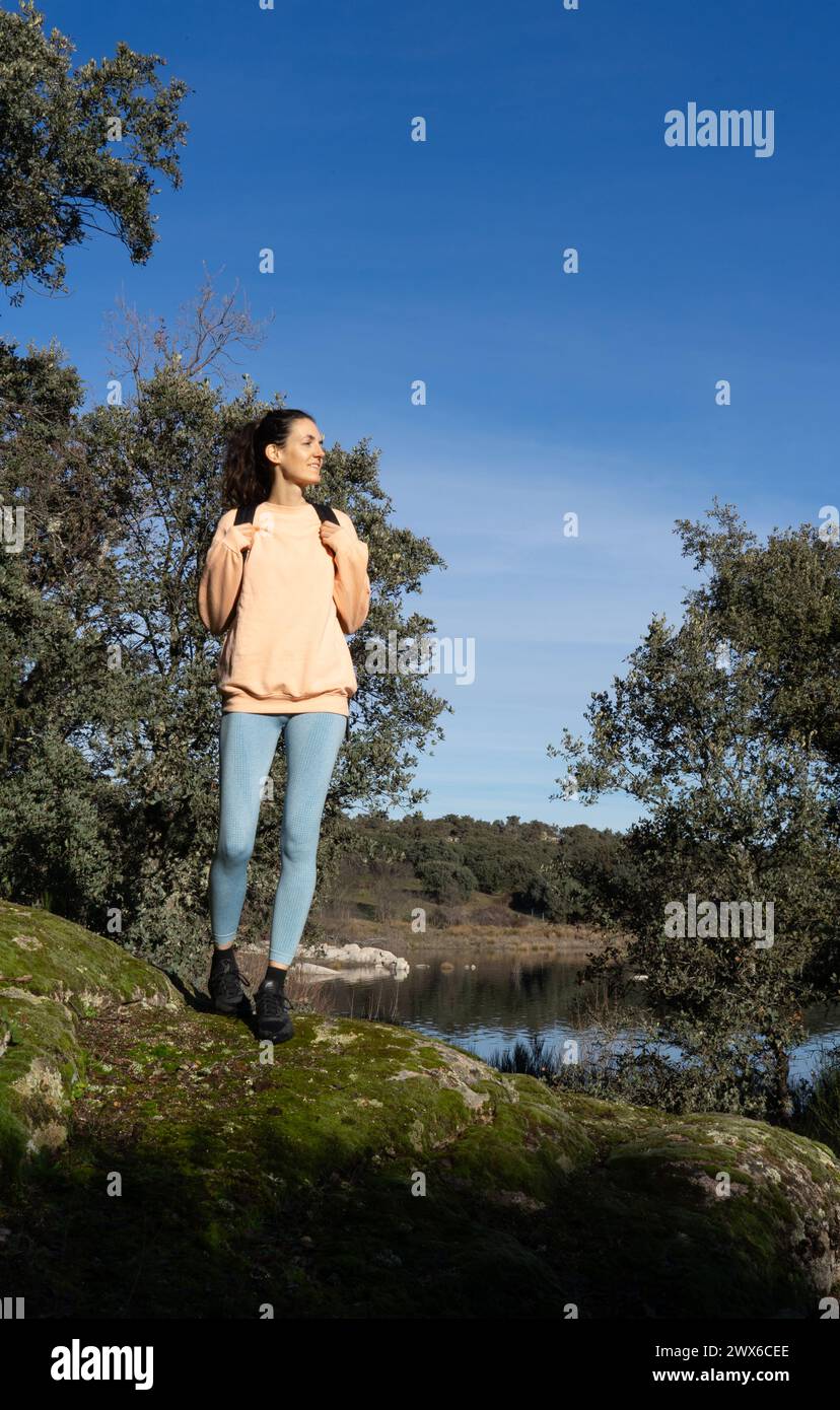 Woman traveling alone on nature hike dressed in peach color Stock Photo ...