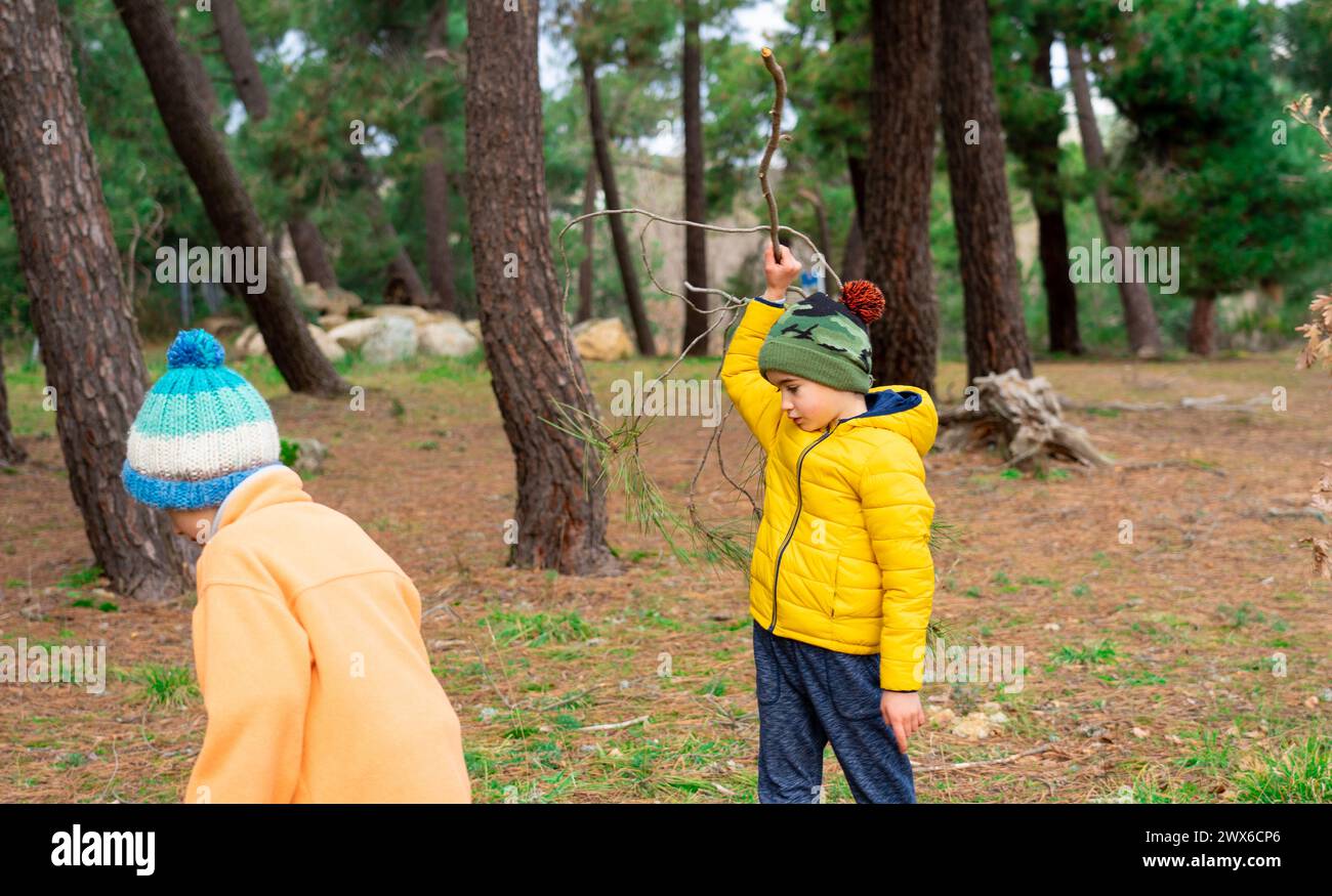 Two children playing in the forest Stock Photo - Alamy