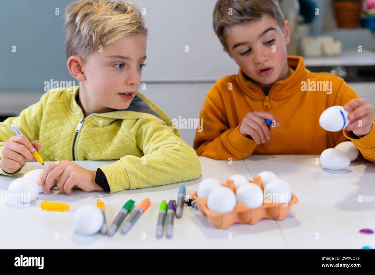 Two children friends decorating Easter eggs together Stock Photo - Alamy