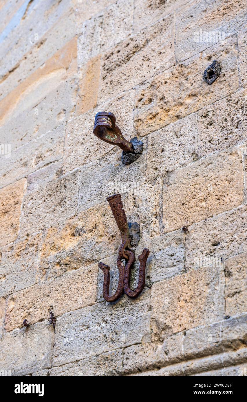 Hand-shaped wrought iron torch holder in the façade of the medieval ...