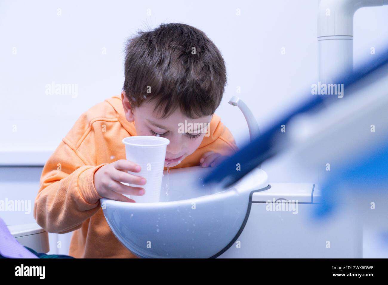 Boy rinsing his mouth at the dentist Stock Photo - Alamy