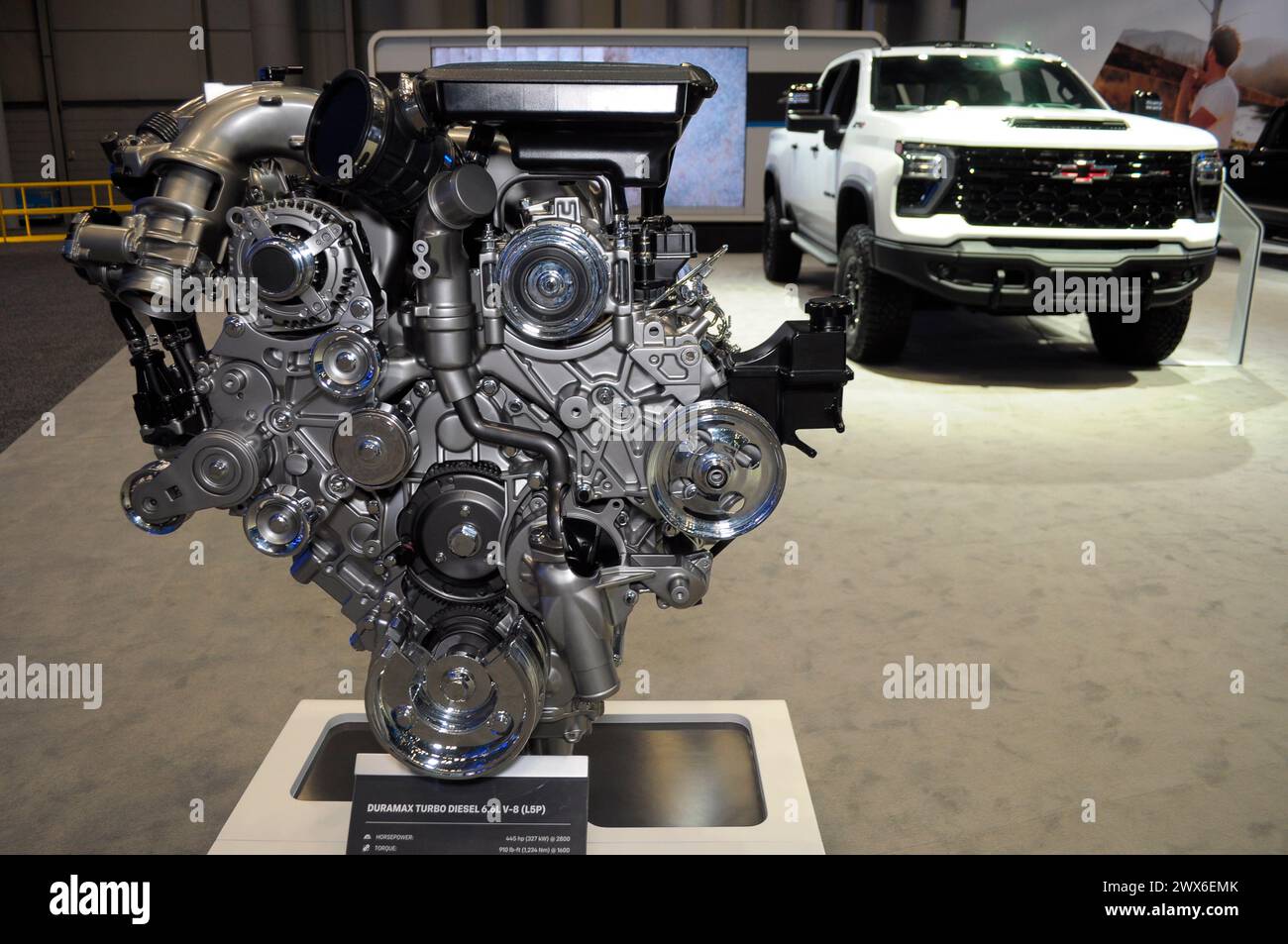 A Duramax Turbo Diesel 6.6L V-8 engine, left, is seen next to a 2024 ...