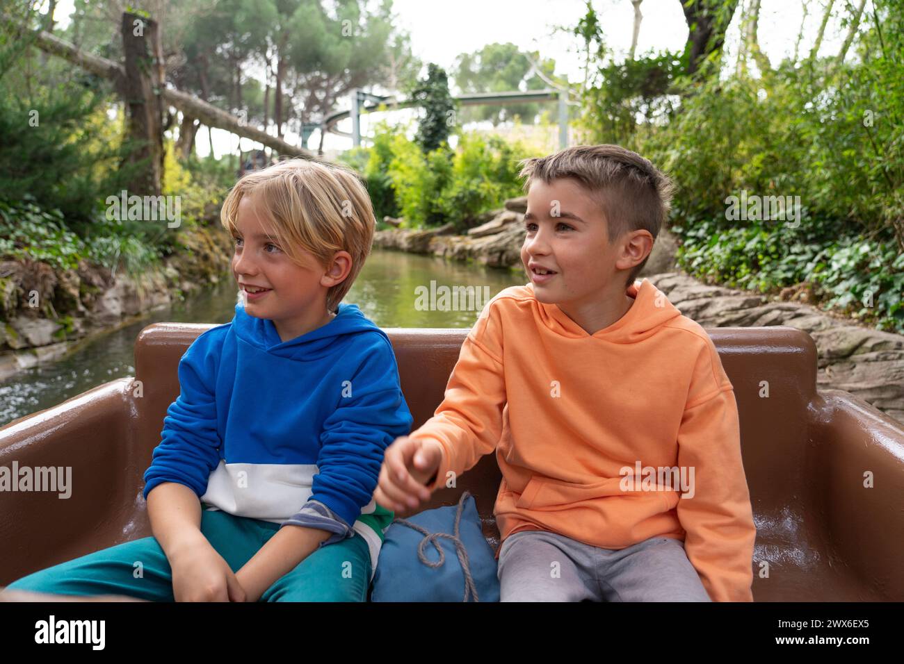 Children riding an amusement park attraction taking a boat ride Stock ...