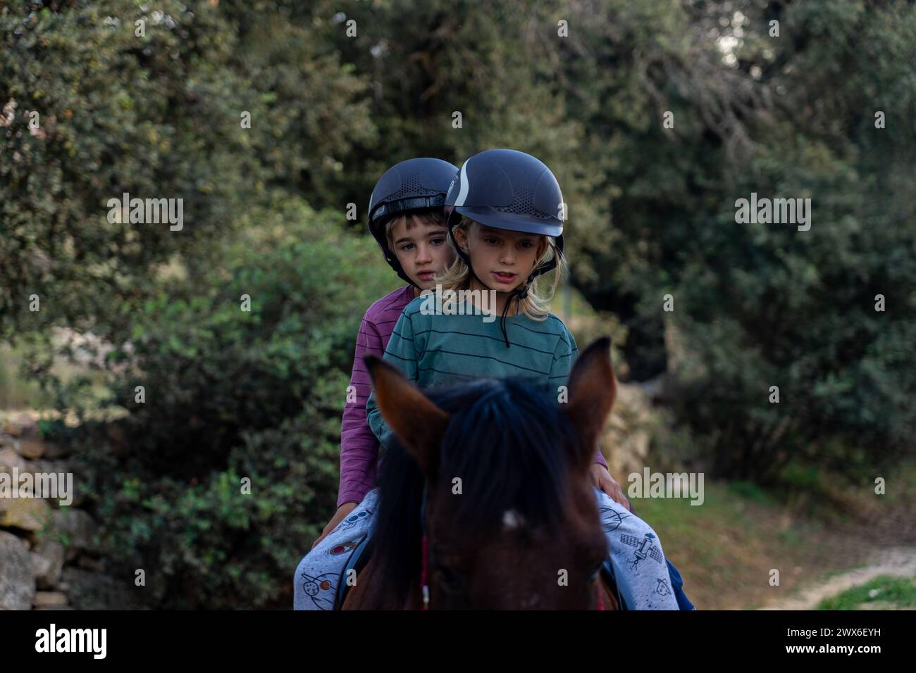 Two boys riding horse in hi-res stock photography and images - Alamy
