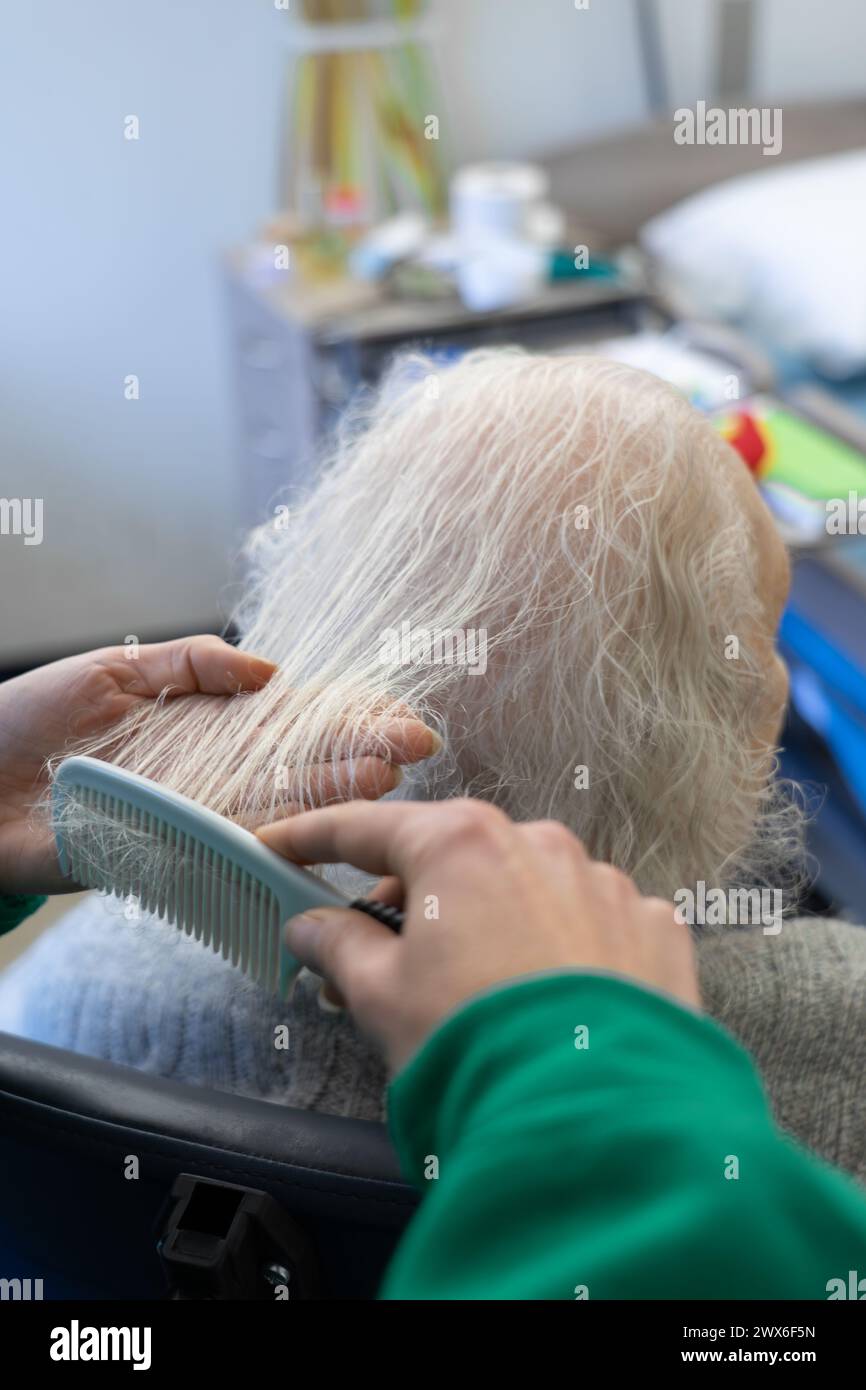 Elderly woman combing hair hi-res stock photography and images - Alamy