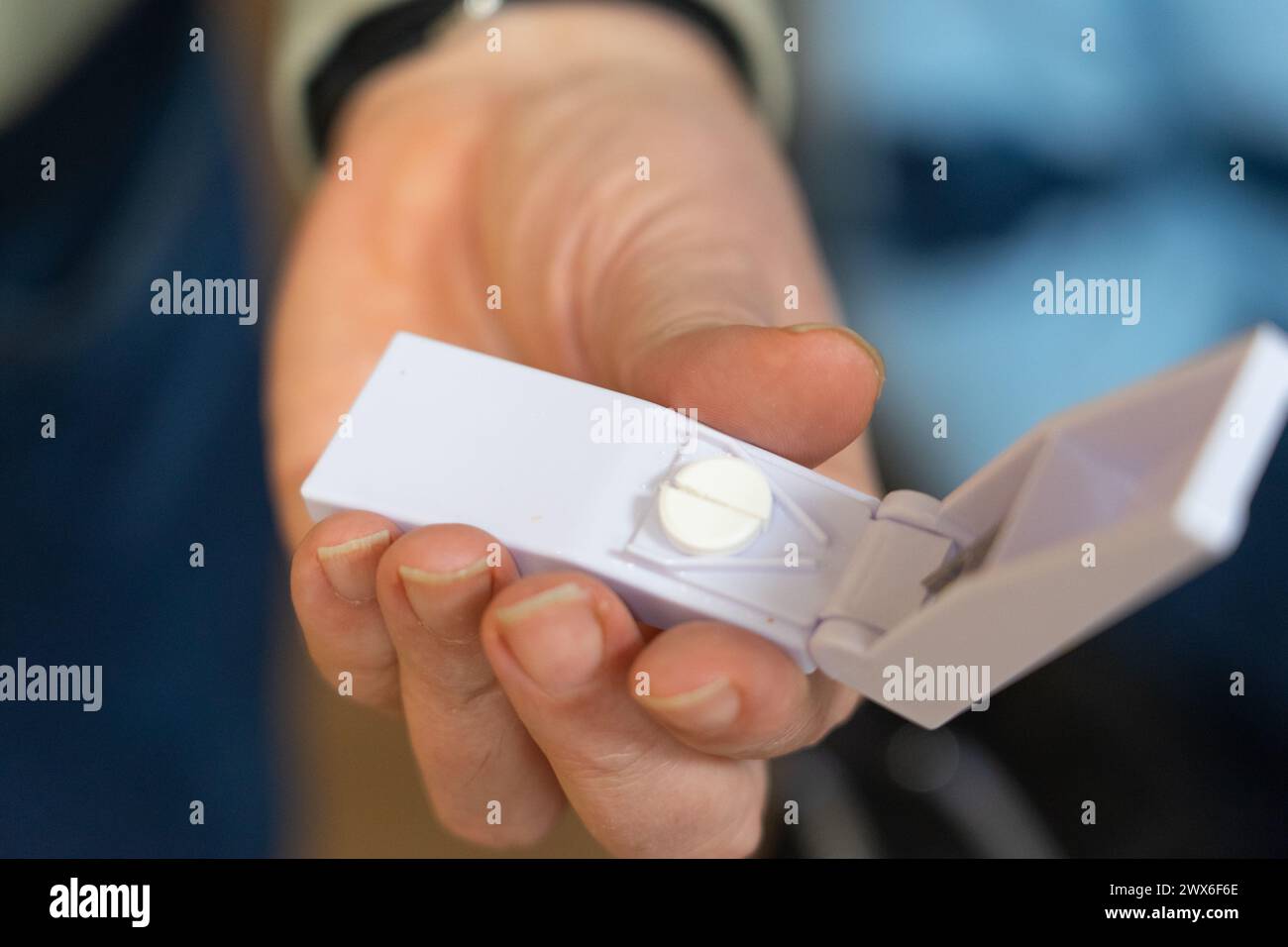 Pill cutter with a cut pill inside Stock Photo - Alamy