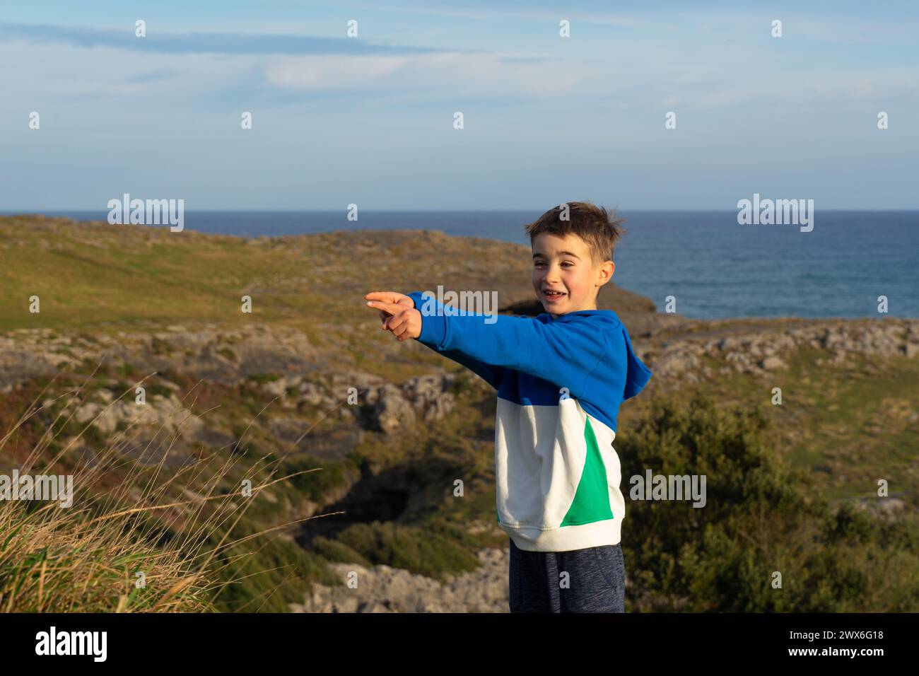 Excited boy pointing at something in a natural landscape Stock Photo ...