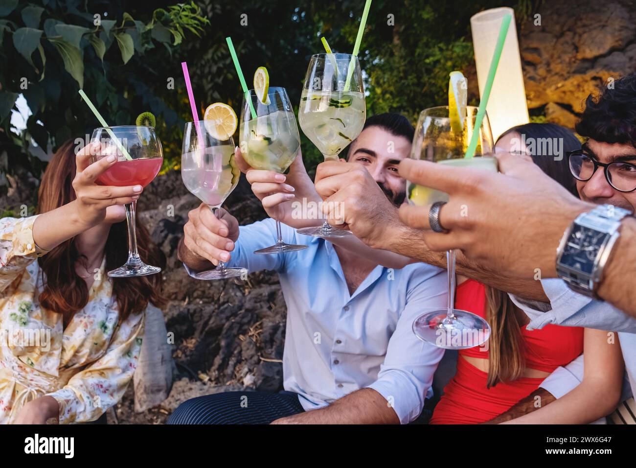 Vibrant group on young adults toasting with cocktails - nature ...