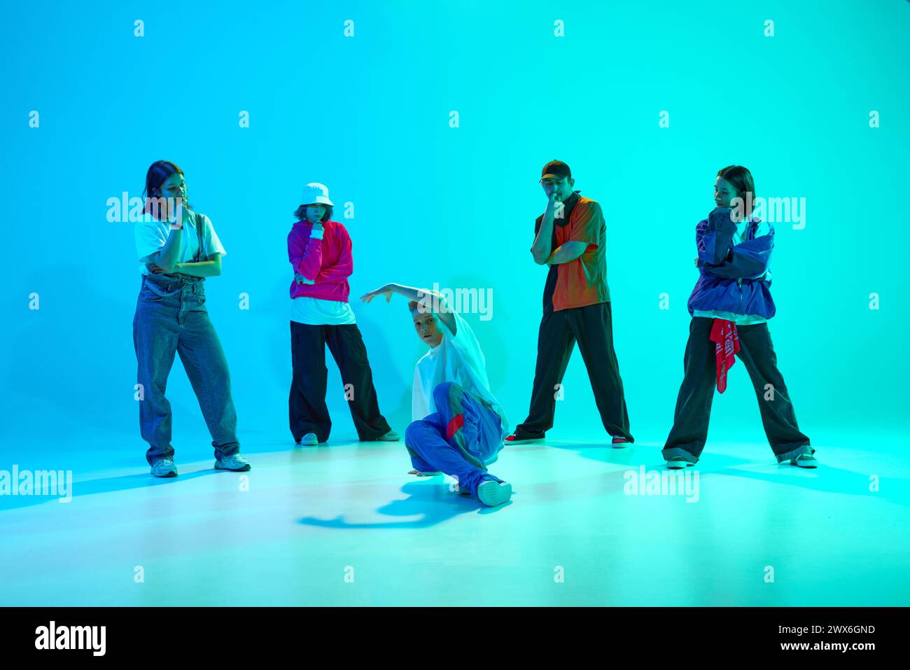 Dance battles. Young guy performing breakdance moves with his dance ...