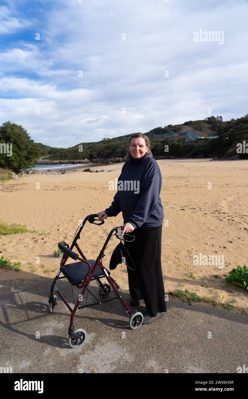 Woman with walker on the beach Stock Photo - Alamy
