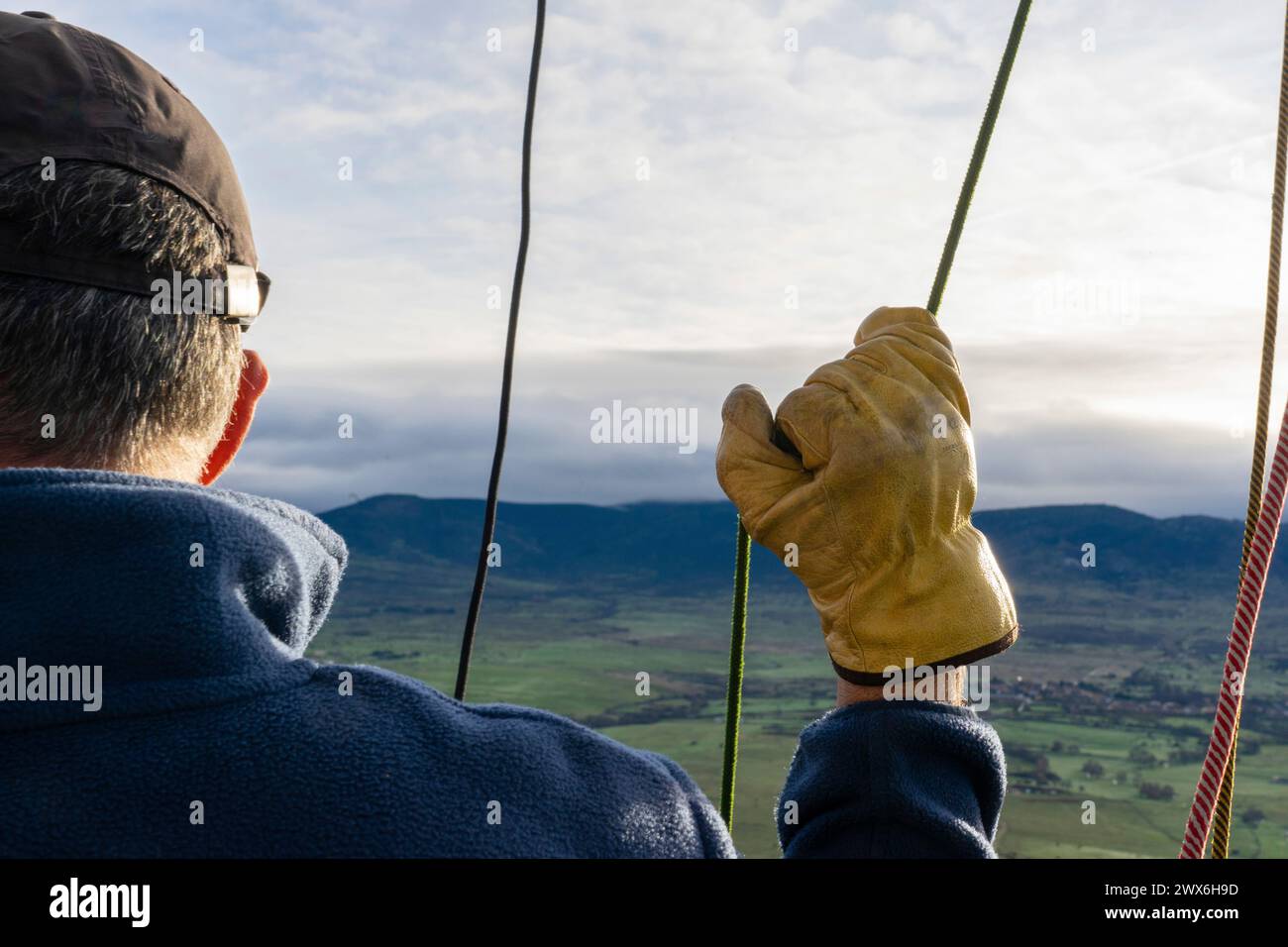 Hot air balloon pilot piloting a flying balloon seen from close up ...