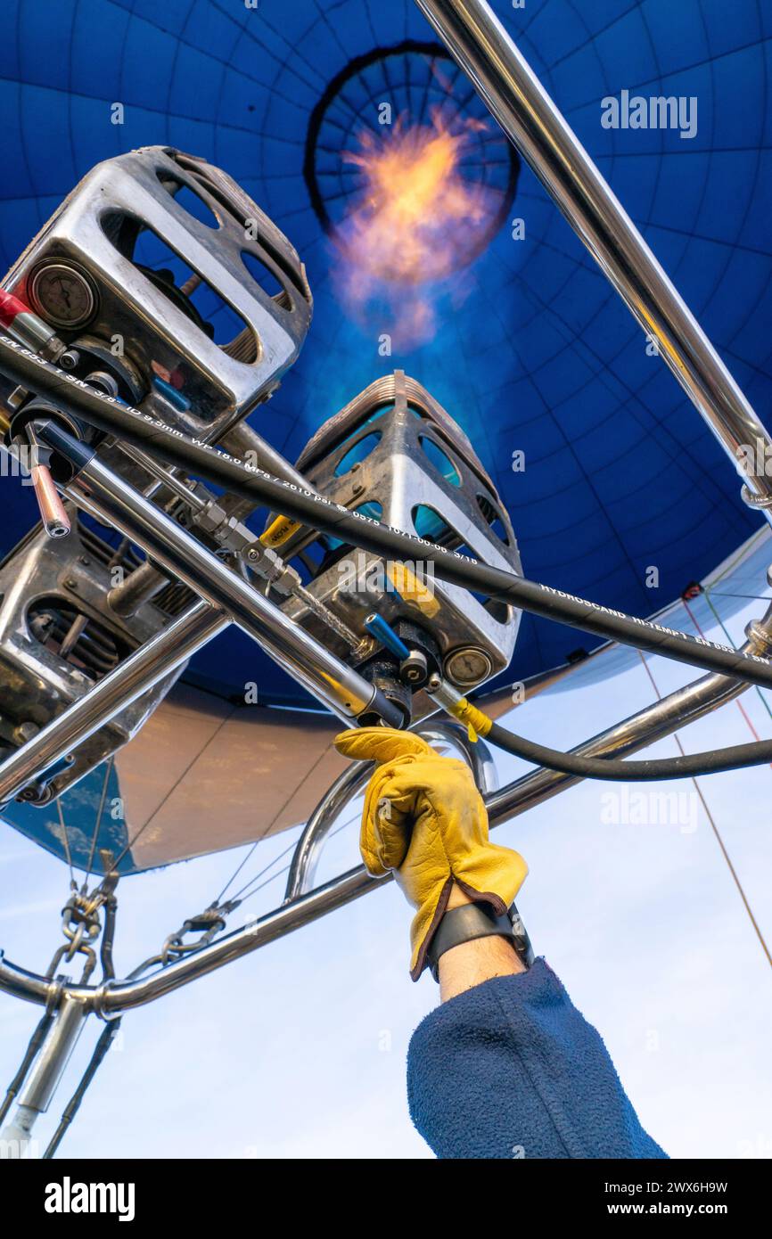 Hot air balloon pilot giving flame to a balloon Stock Photo - Alamy