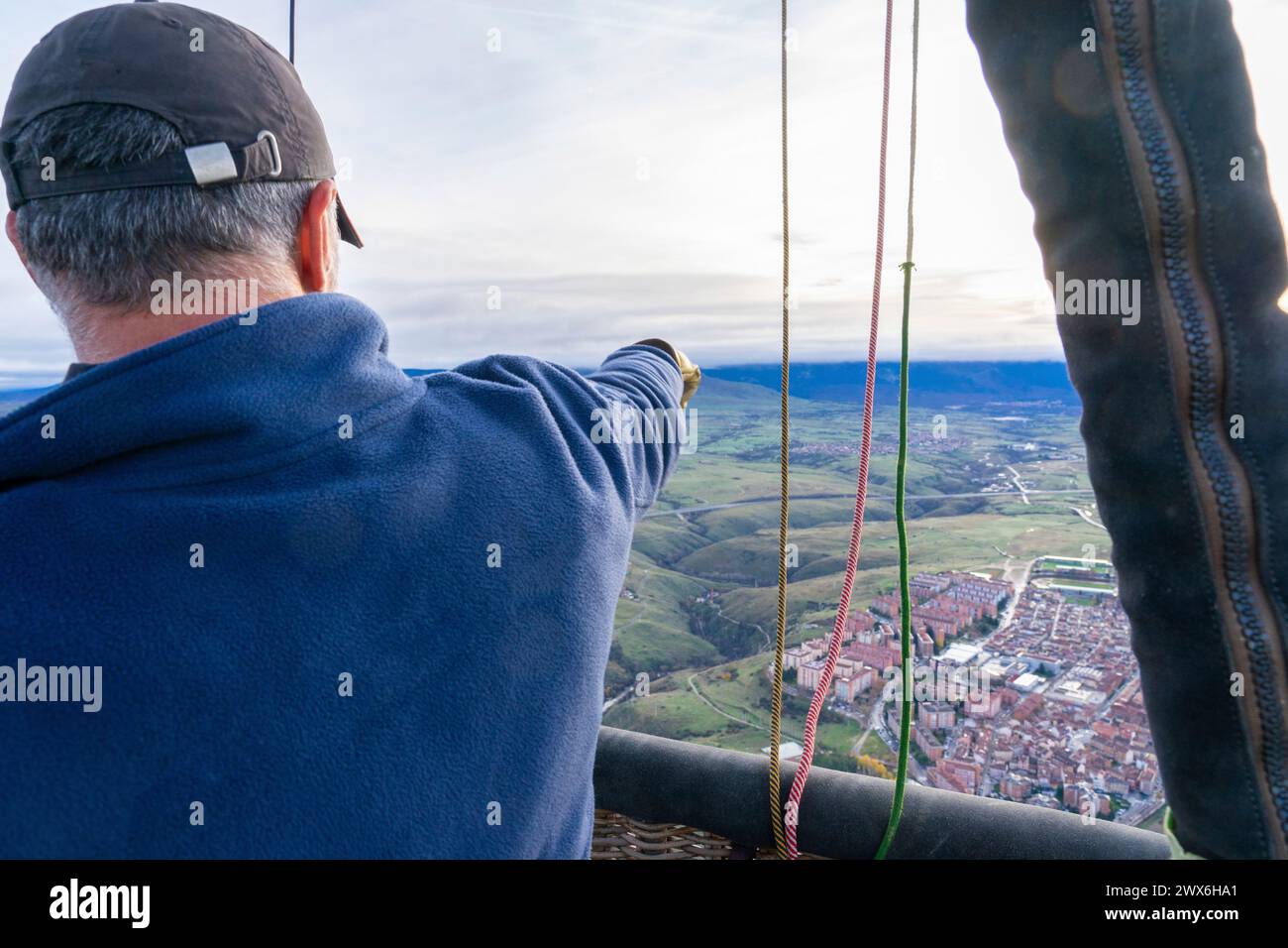 Hot air balloon pilot flying in balloon pointing out the sights Stock ...