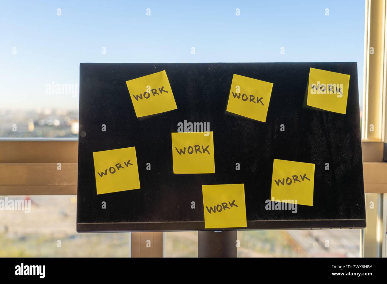 Computer monitor with post it notes stuck with the word work Stock ...