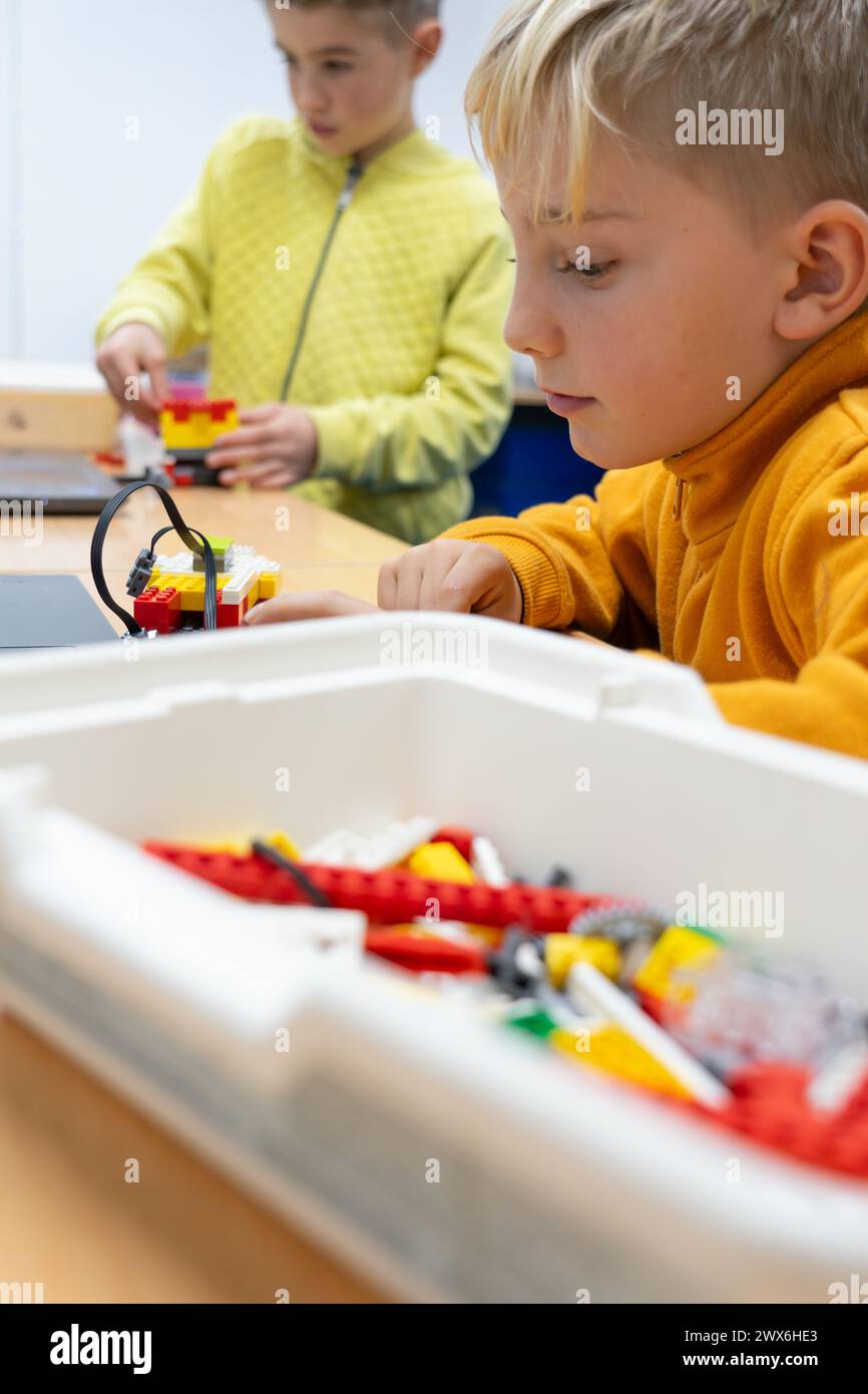 Children in robotics class creating a robot with the computer Stock ...