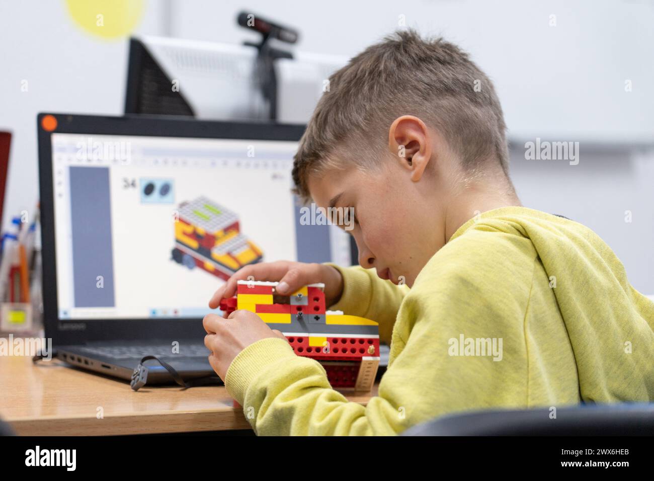 Concentrated boy building a robot in a robotics workshop Stock Photo ...