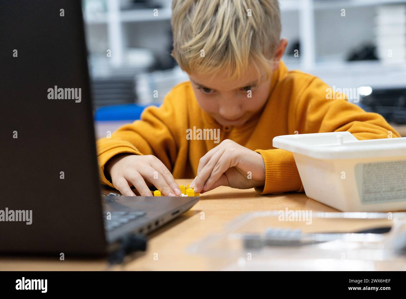 Boy building a robot in a robotics class Stock Photo - Alamy