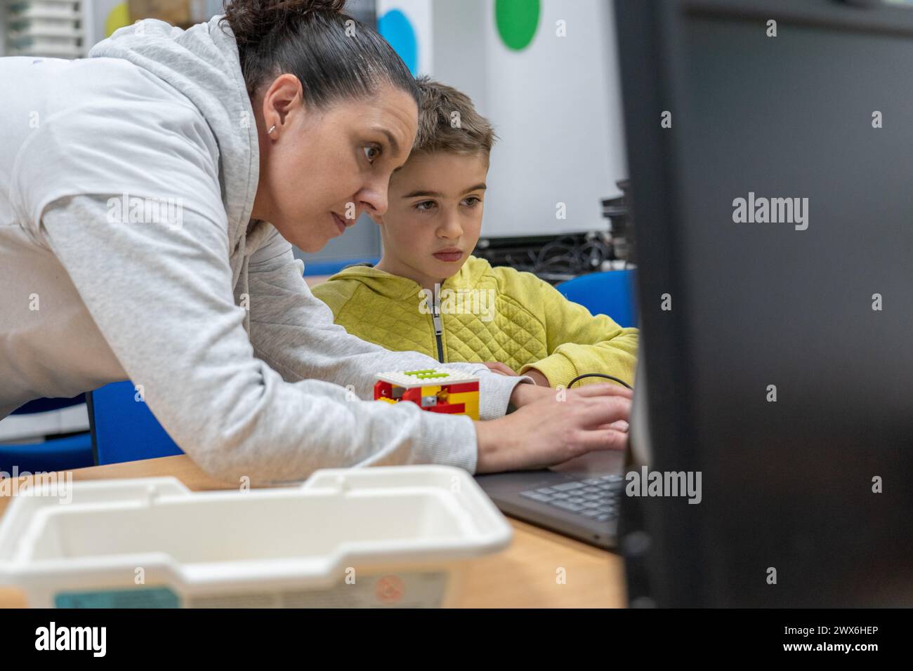 Robotics class with a teacher and a child learning Stock Photo - Alamy
