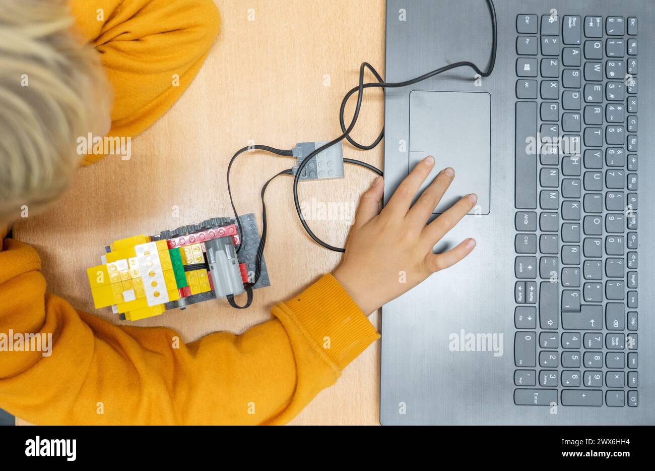 Child's hand using a computer in a robotics class for children viewed ...