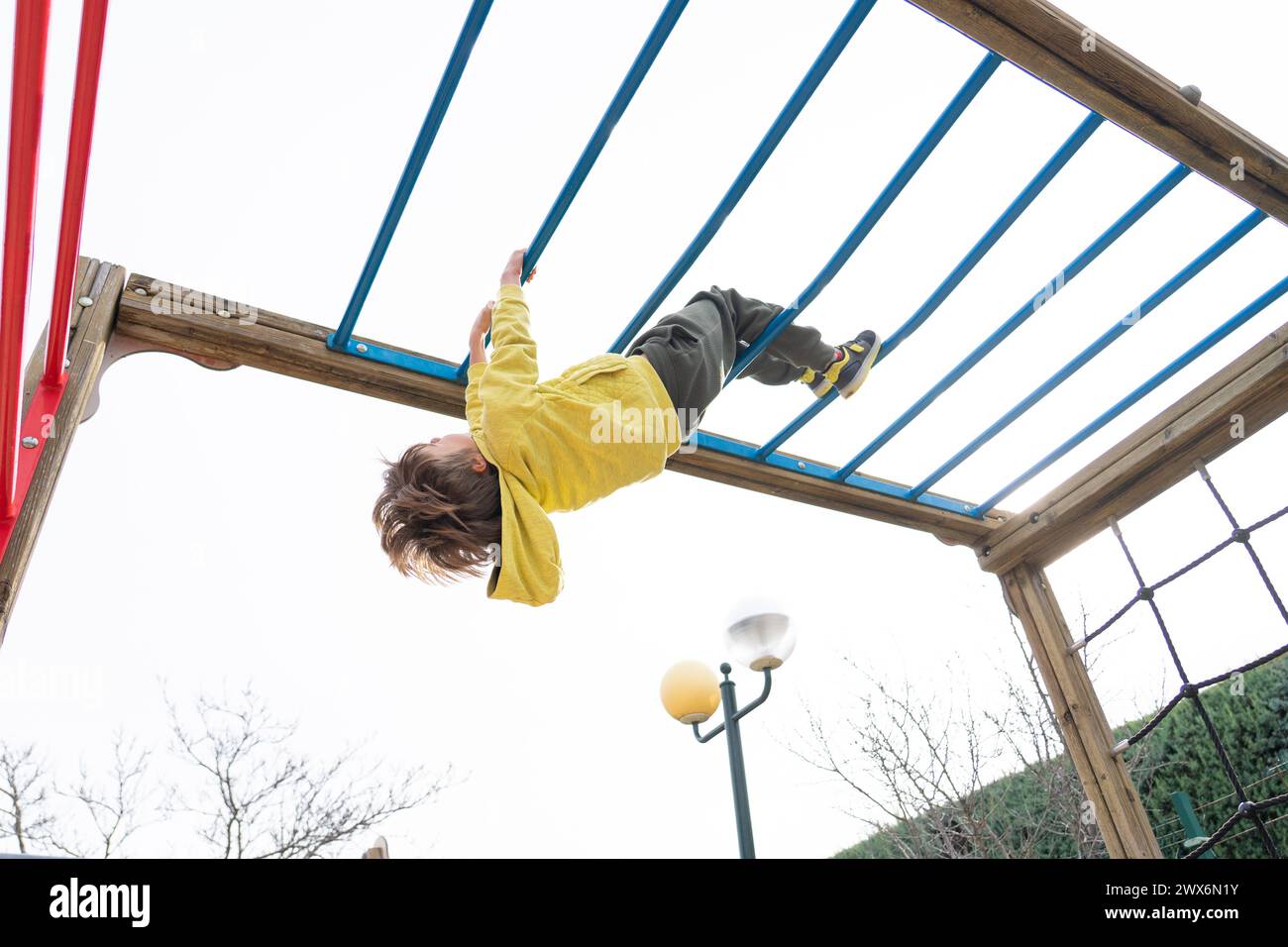 Child playing in a playground structure Stock Photo - Alamy