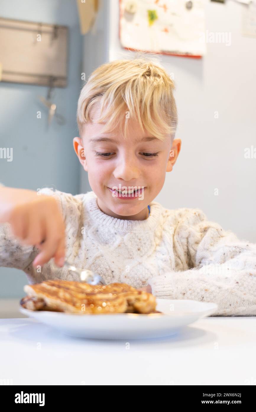 Kid eating breakfast in kitchen hi-res stock photography and images - Alamy