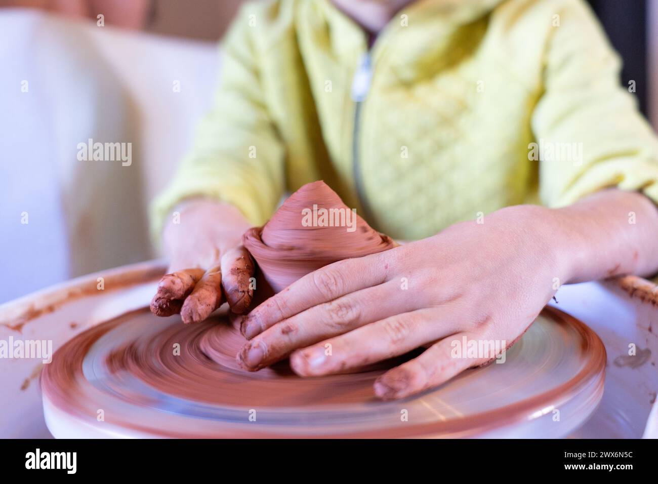 Child's hands making wheel with clay Stock Photo - Alamy