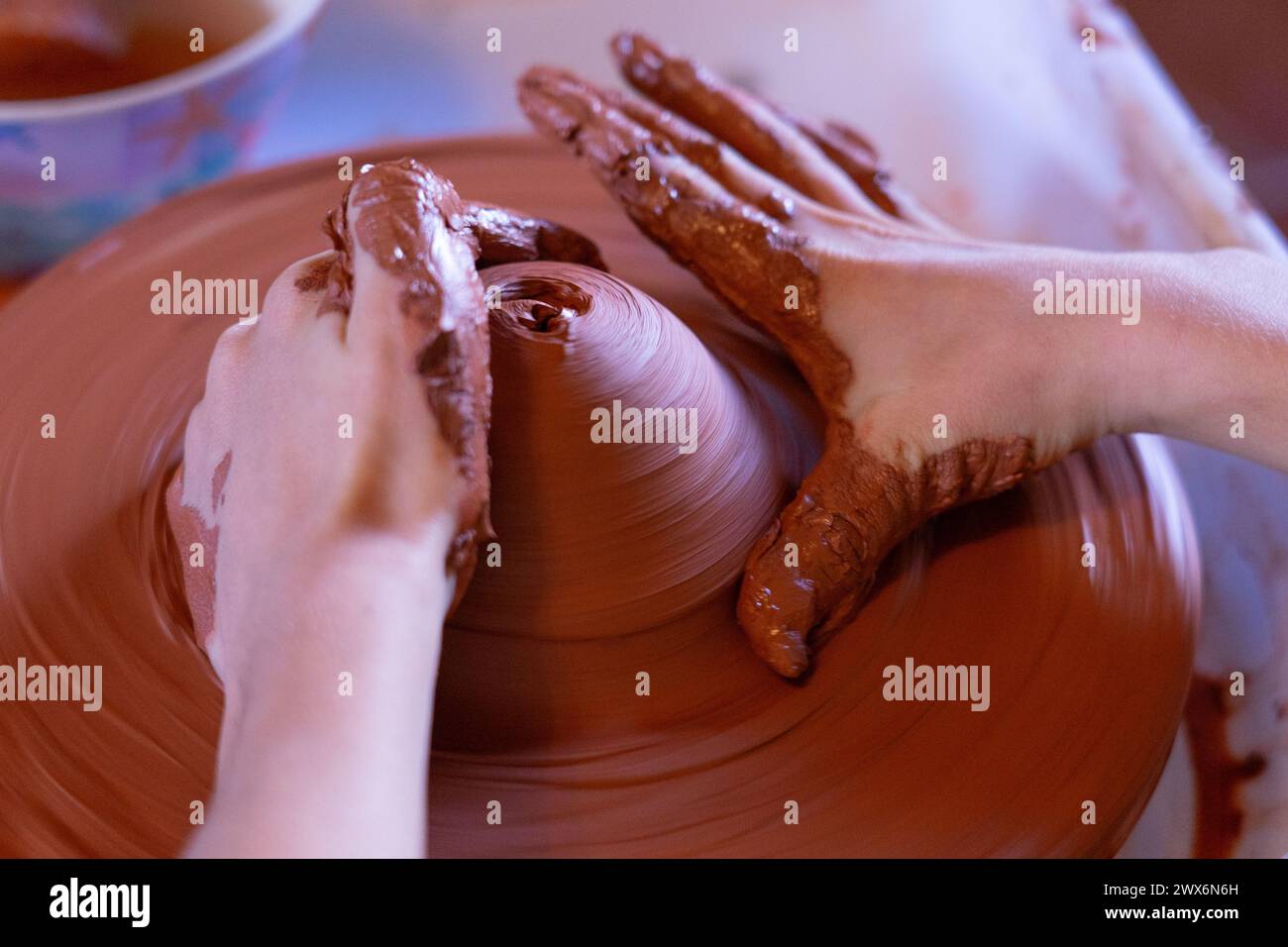 Child's hands shaping a piece of clay on a wheel Stock Photo - Alamy