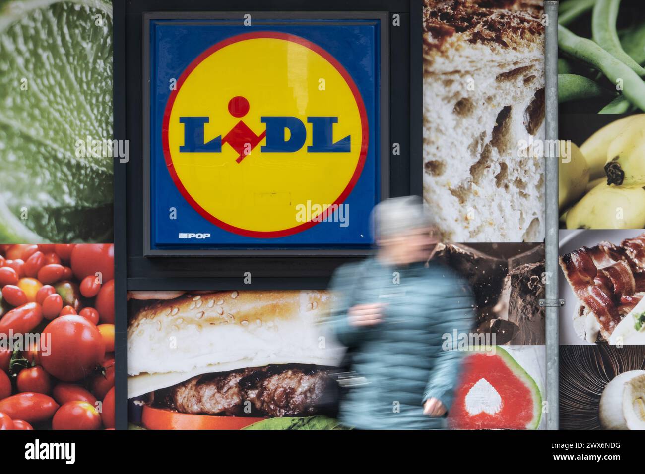 Stuttgart, Germany. 28th Mar, 2024. A passer-by walks past the outdoor ...