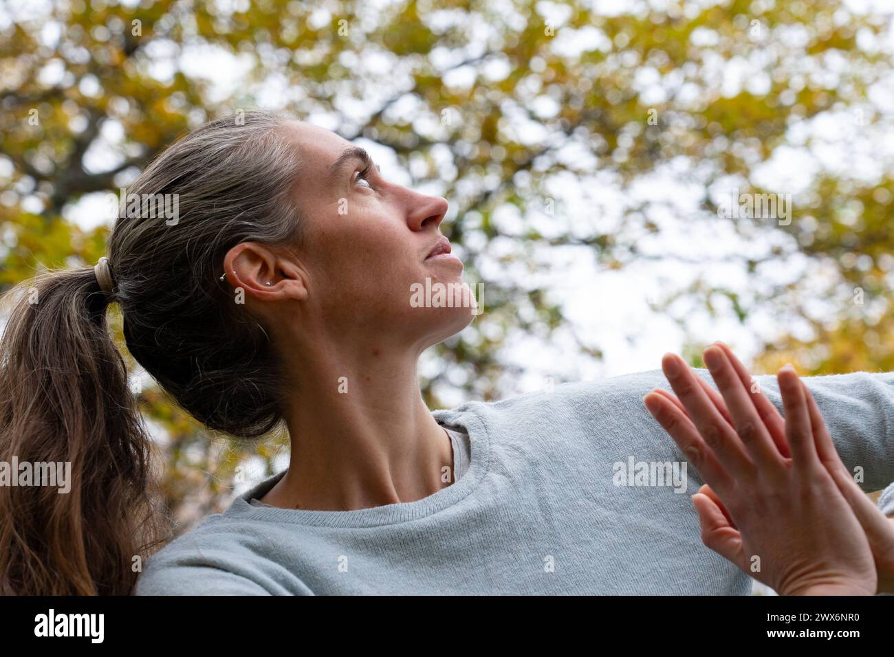Woman doing yoga outdoors seen from close up Stock Photo - Alamy