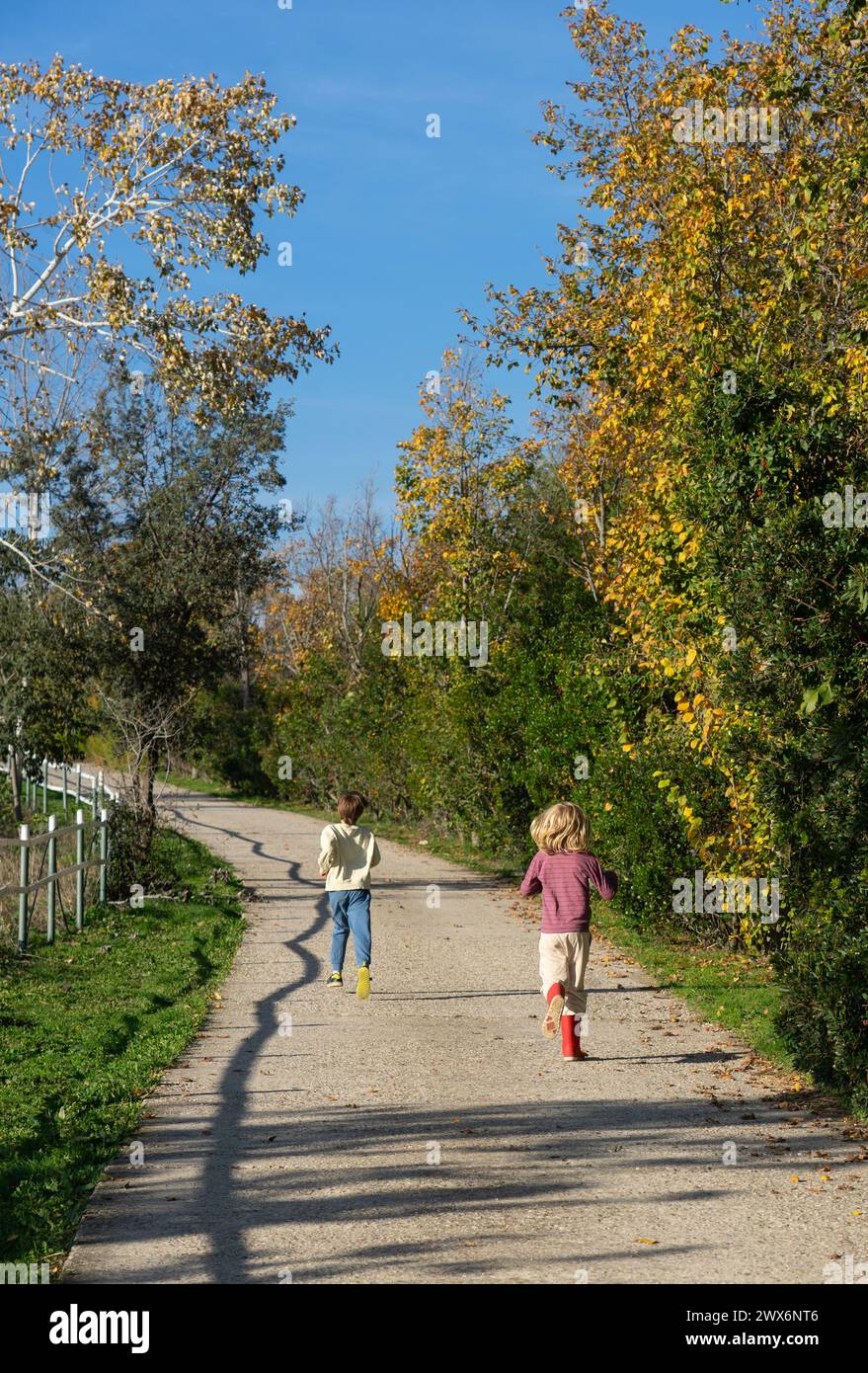 Two children running along a path in the countryside Stock Photo - Alamy