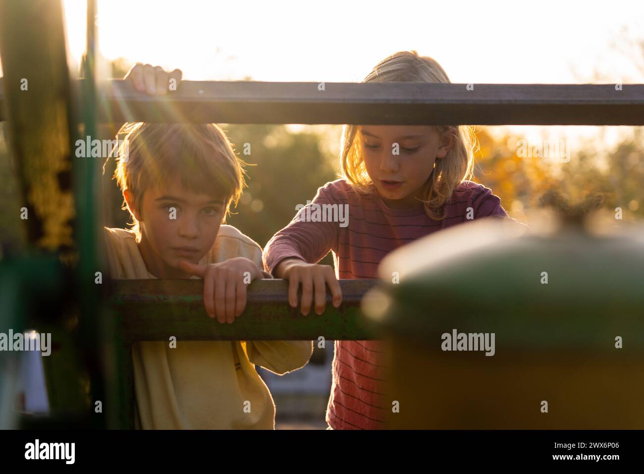 Two children playing outdoors on a farm seen from close up Stock Photo ...