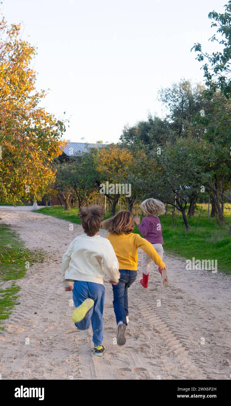 Three children running along a path through the countryside Stock Photo ...