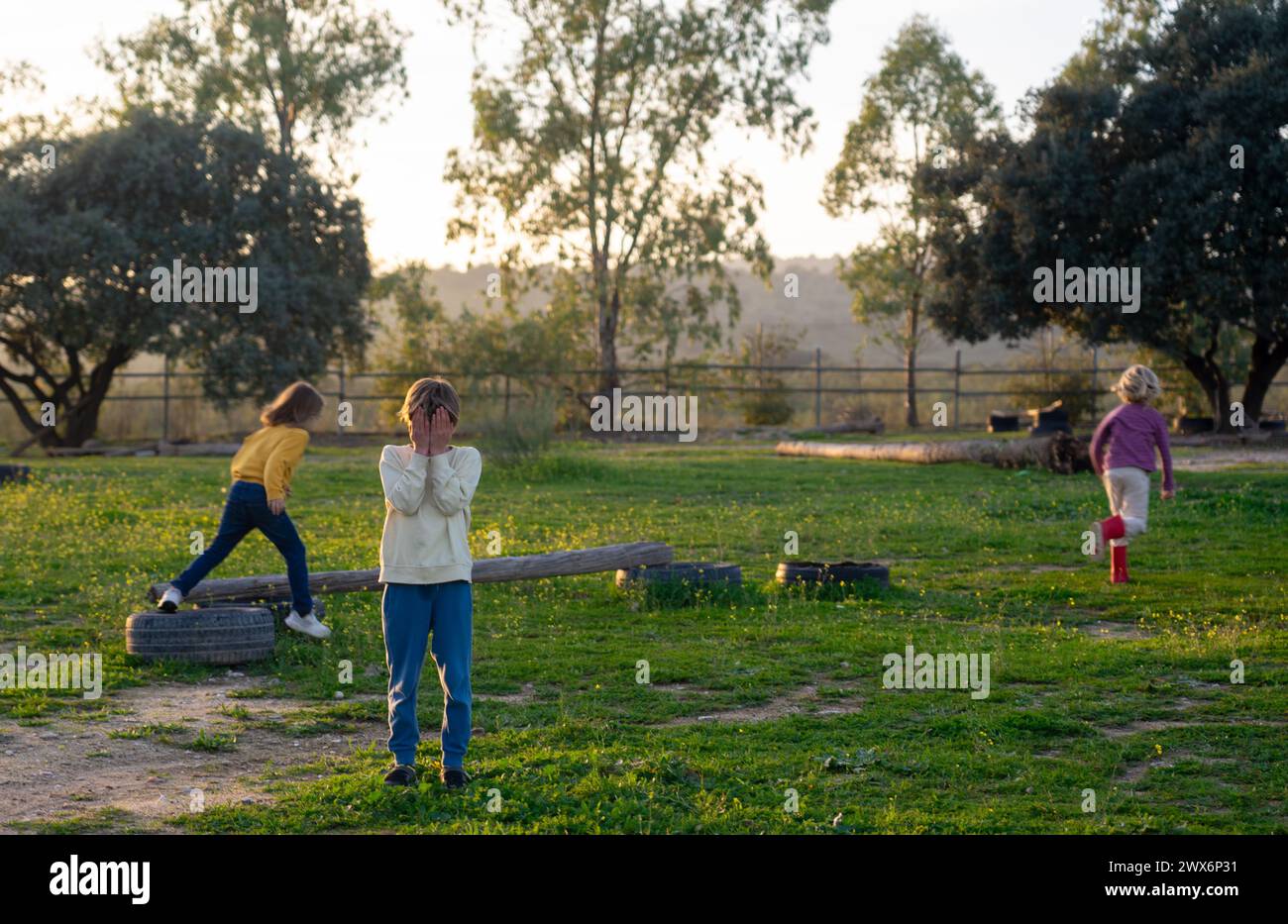 Children playing hide and seek in the field outdoors Stock Photo - Alamy