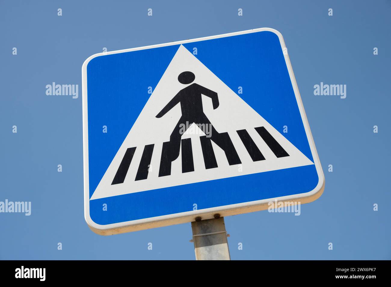 Low angle view of a Spanish pedestrian zebra crossing road sign ...