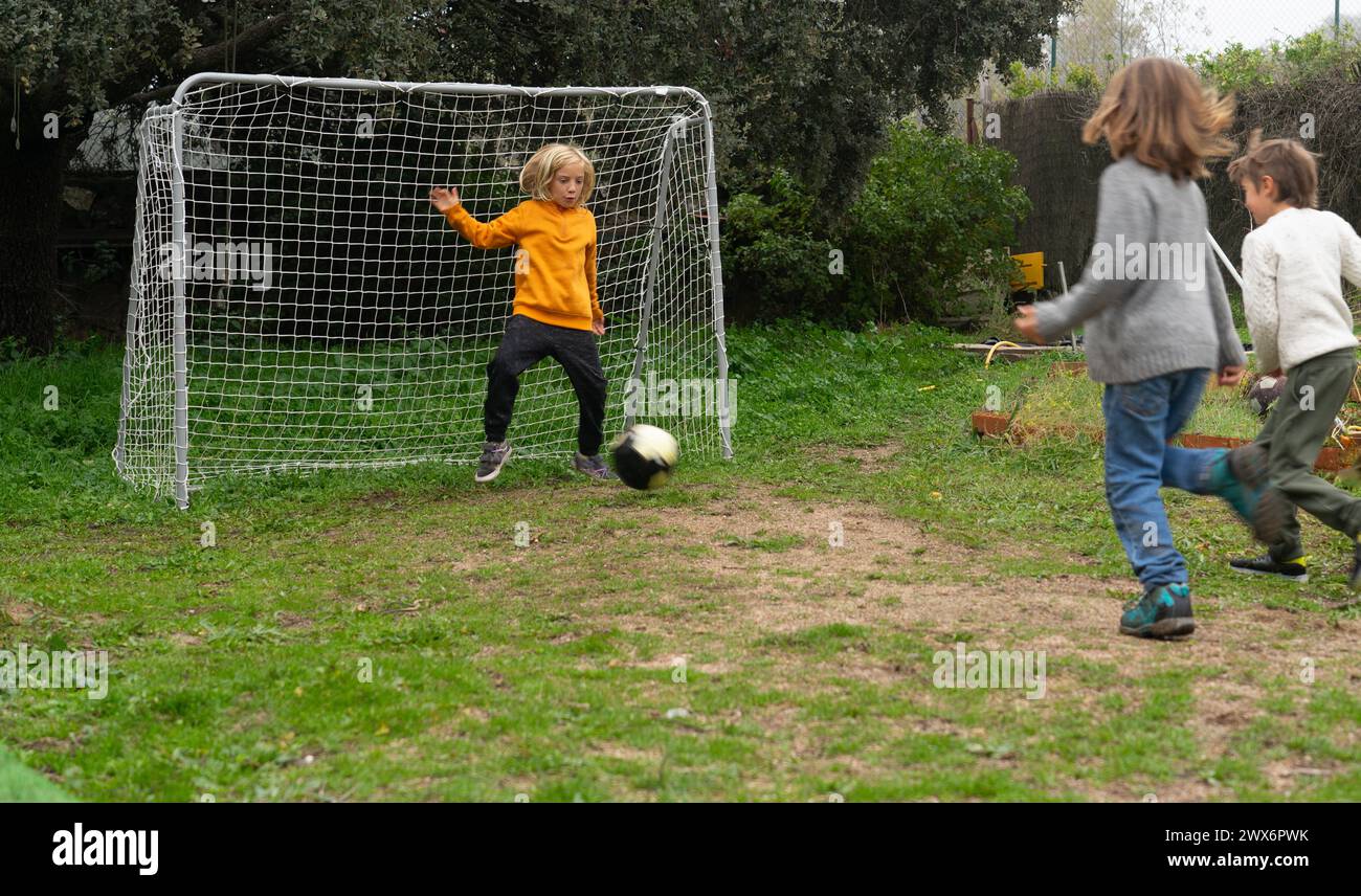 Children friends playing soccer outdoors Stock Photo - Alamy